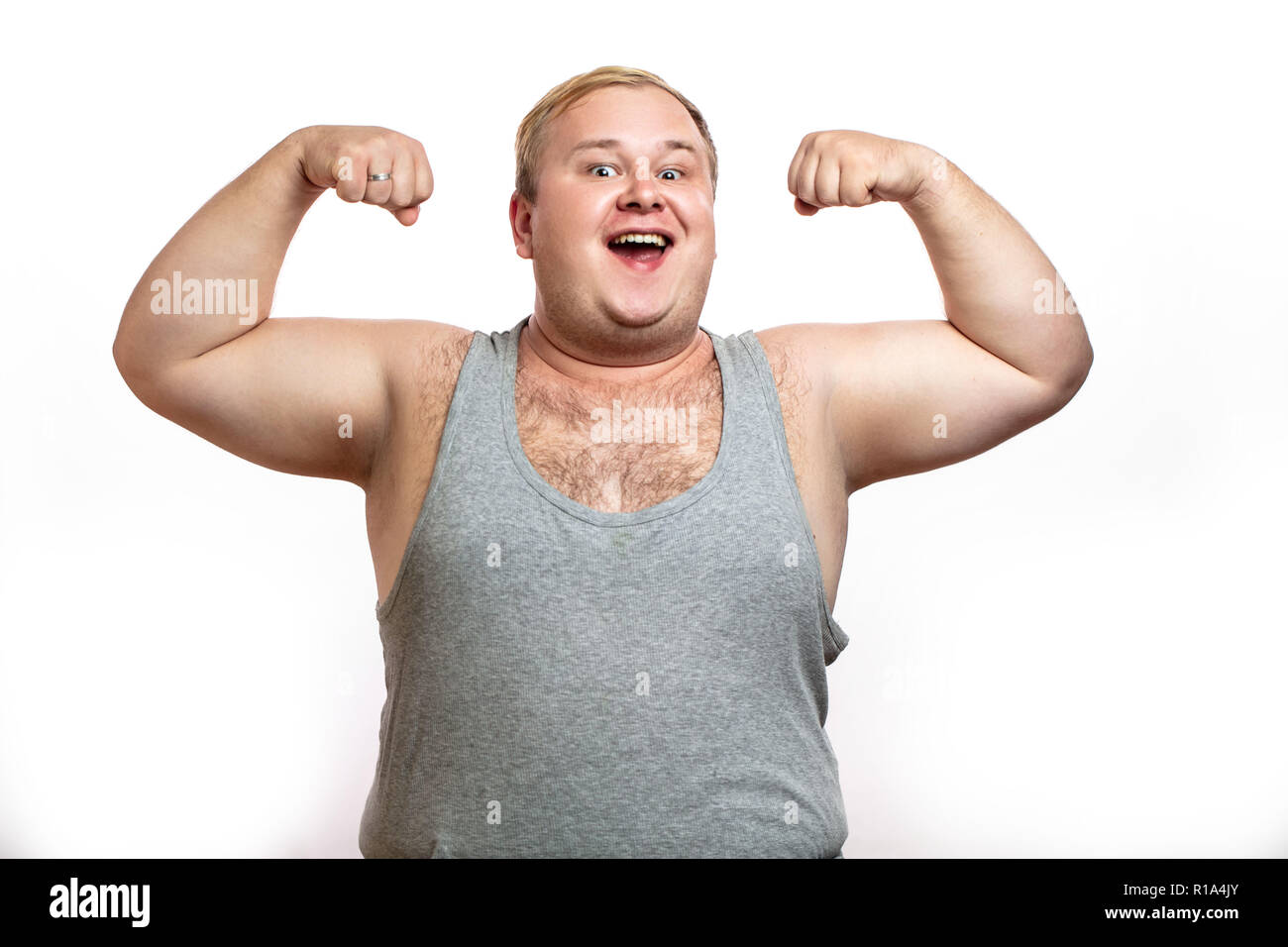 Funny overweight sports man flexing his muscle isolated on white ...