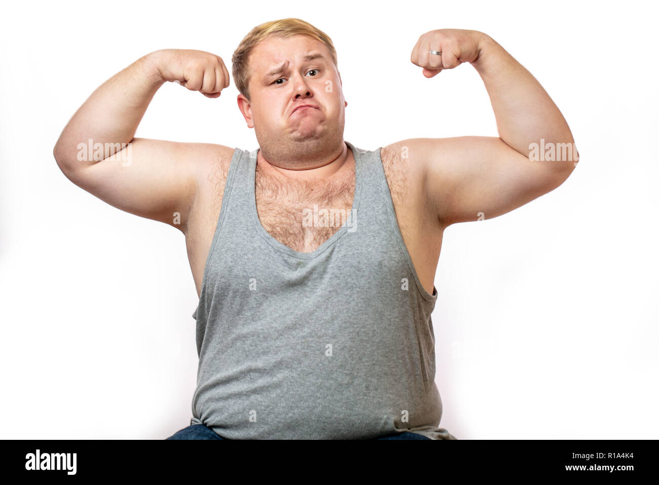 Funny overweight sports man flexing his muscle isolated on white ...