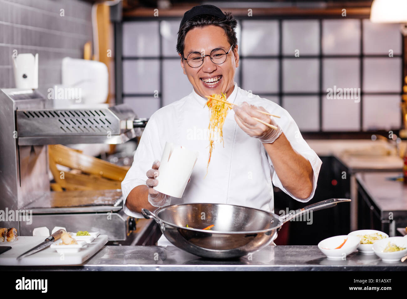asian chef with noodle in the kitchen Stock Photo - Alamy