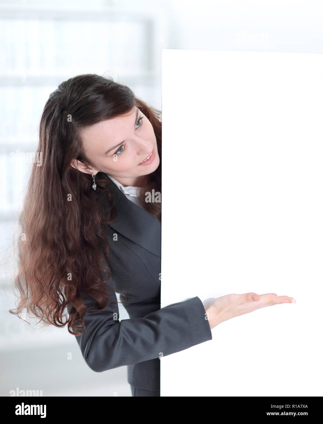 smiling business woman showing at blank poster Stock Photo - Alamy