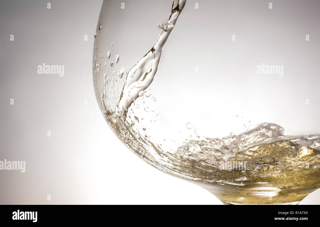 Stream of wine being pouring into a glass closeup, wine, splashing ...