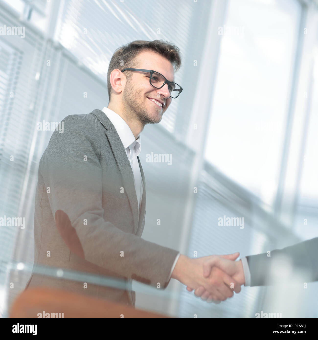 close up.modern young man shaking hand with the Manager Stock Photo - Alamy