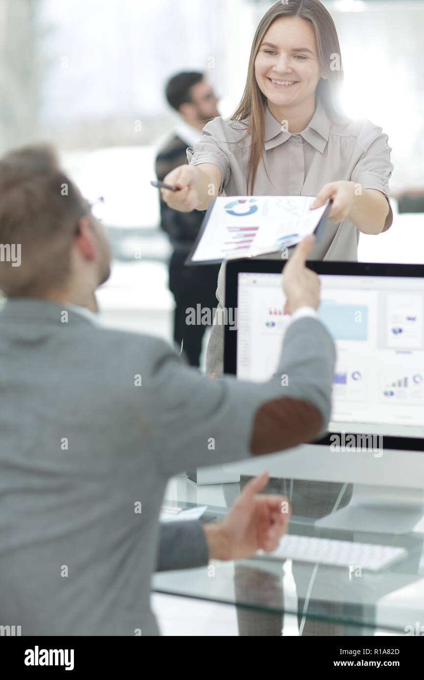 female assistant gives the employee a financial document Stock Photo ...