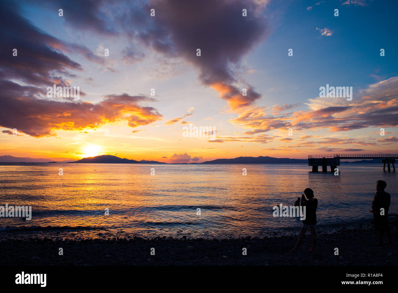 Scenic sunset at the shore of Batangas, Philippines Stock Photo - Alamy