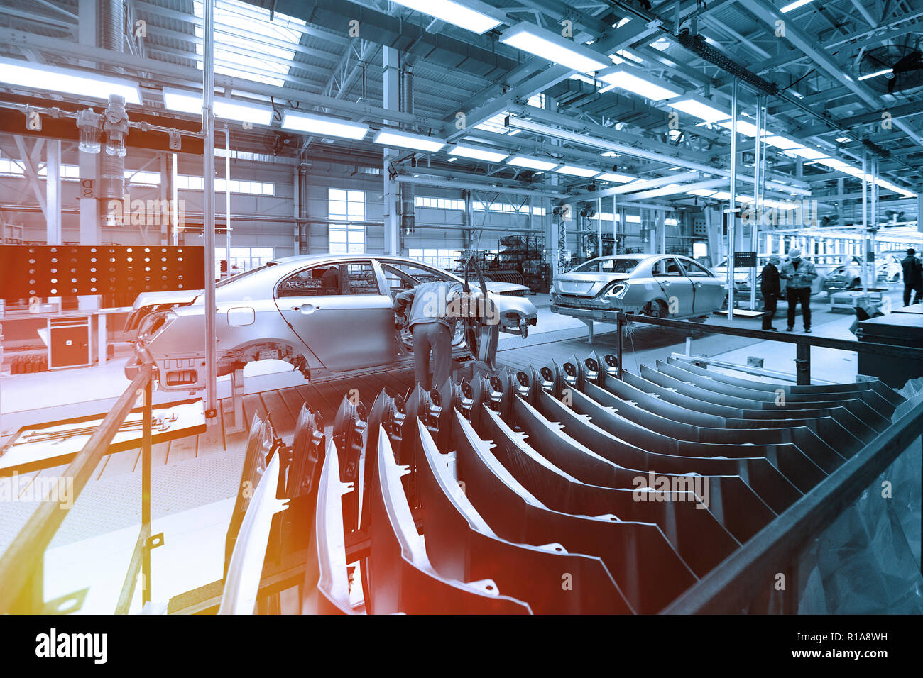 Worker looks into car body on production line. Factory for production ...
