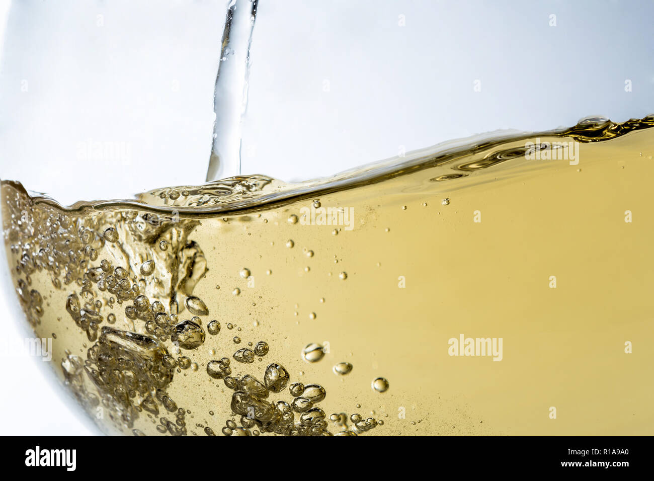 Stream of wine being pouring into a glass closeup, wine, splashing ...
