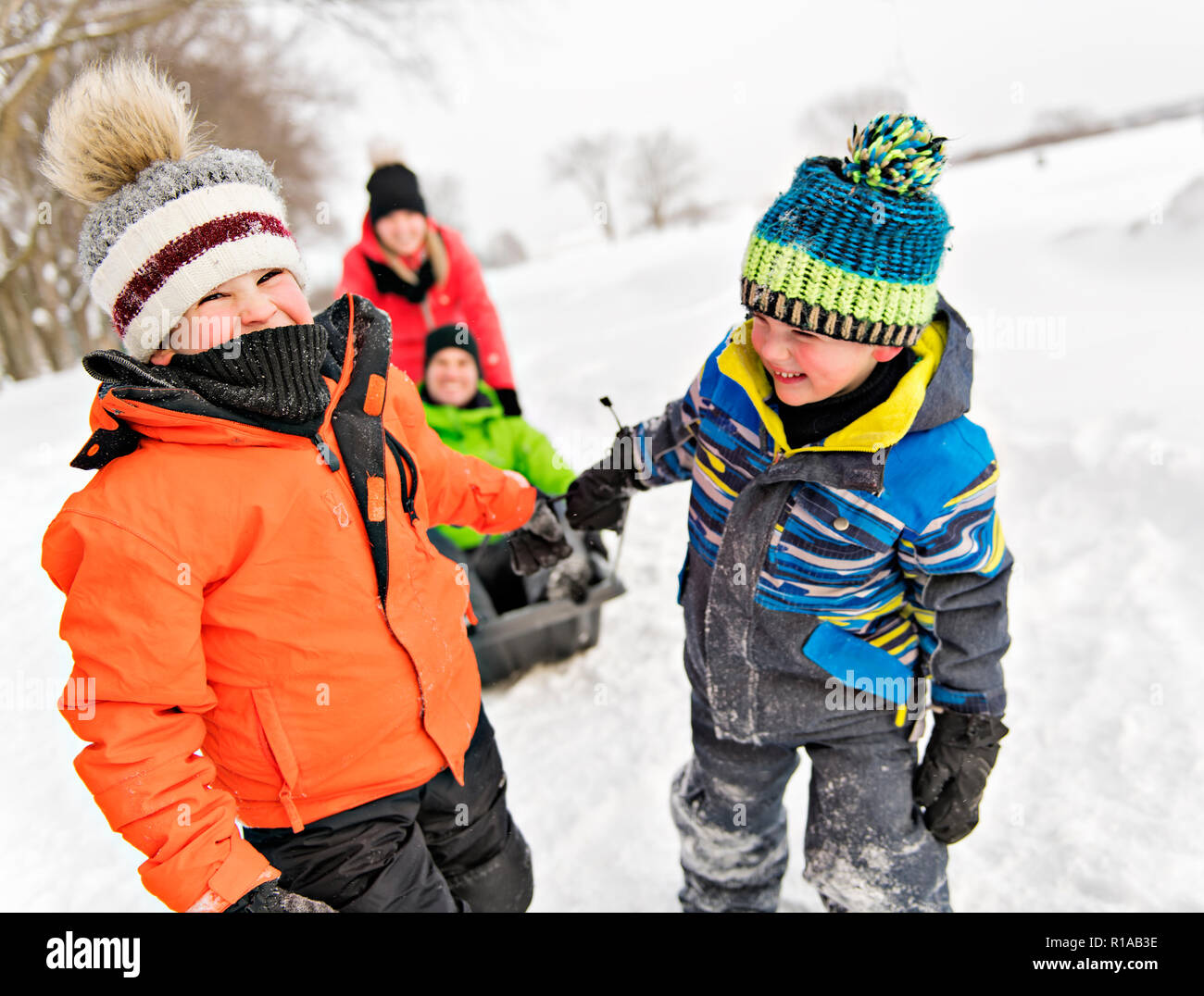 Child boy Pulling Sledge Through Snowy Landscape Stock Photo - Alamy