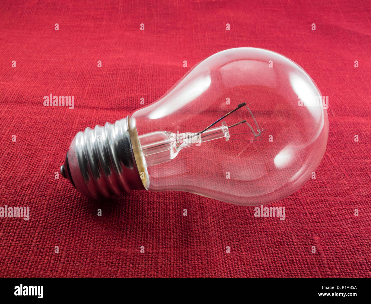 Light bulb on red background Stock Photo - Alamy