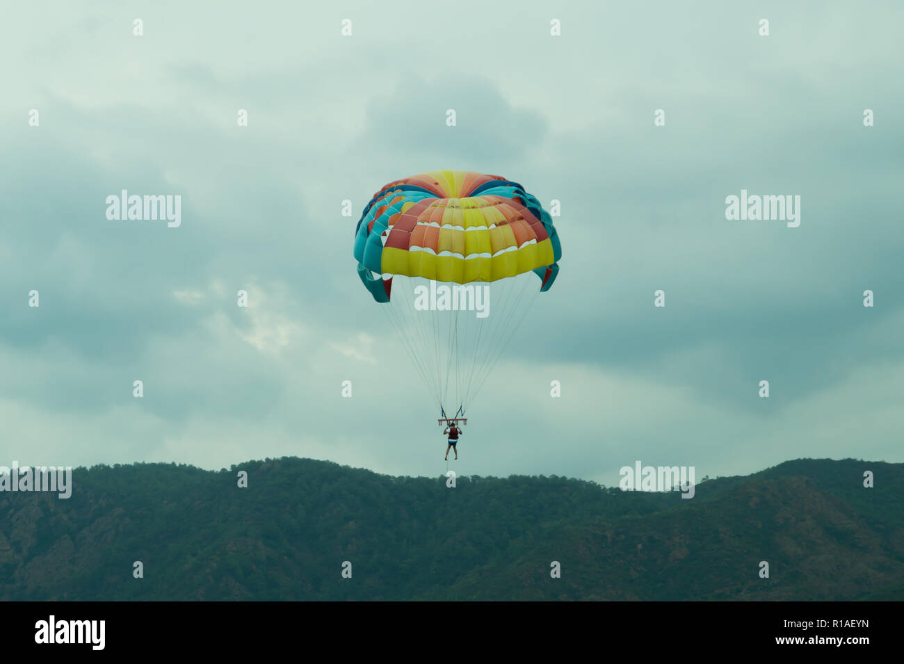 Skydiver flying with a colorful parachute Stock Photo - Alamy