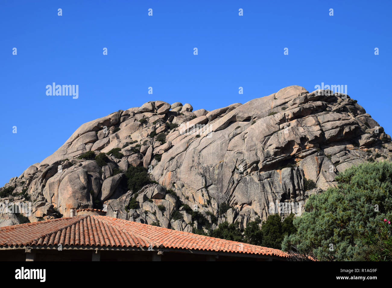 round and smooth granite formation in the foreground a roof covered ...