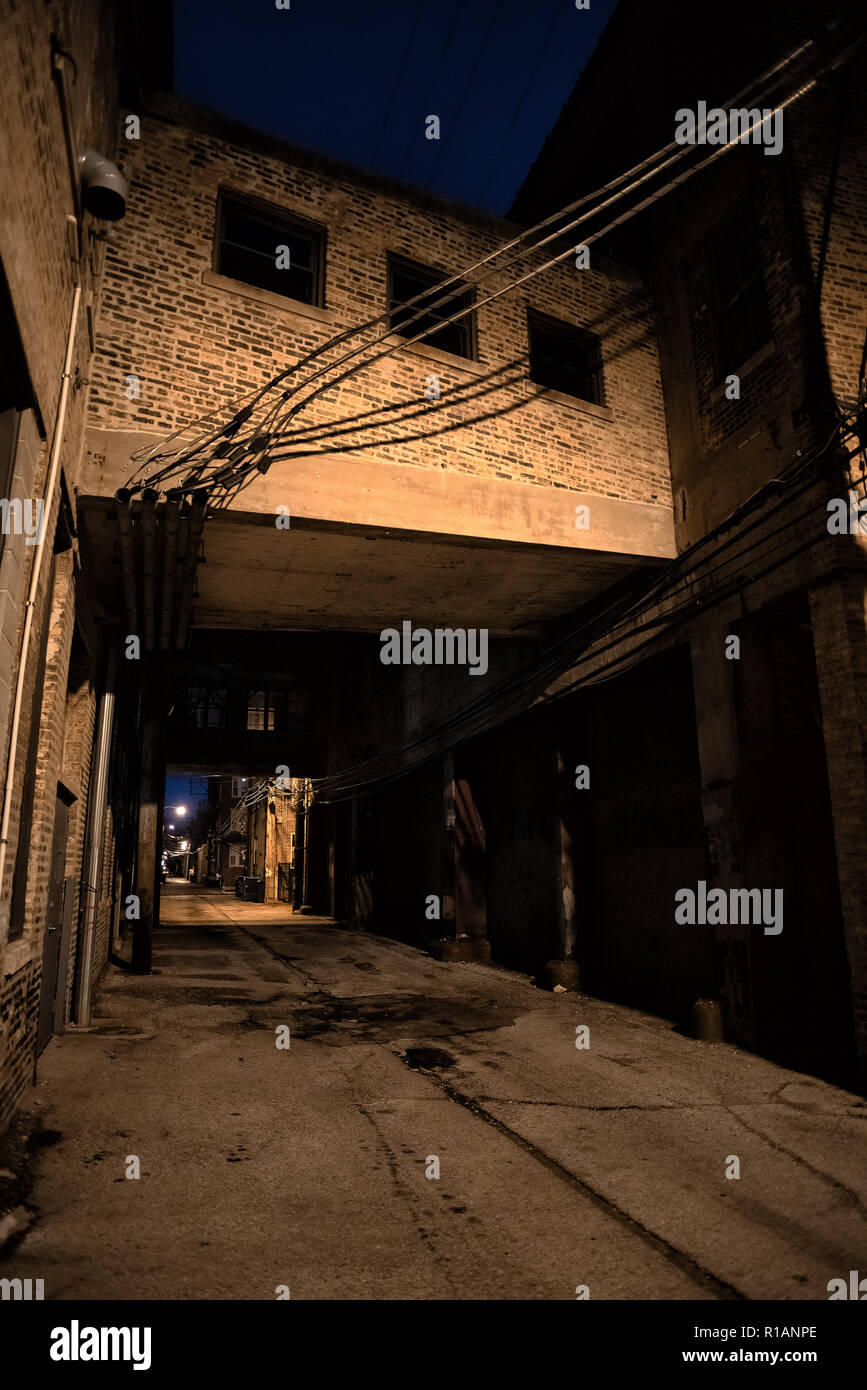 Dark and scary downtown urban city street alley scene with an eerie ...