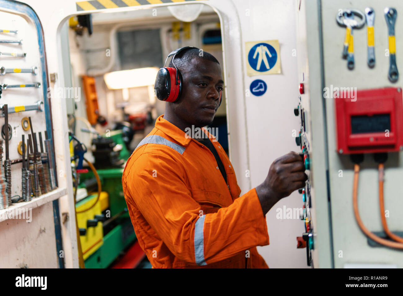 Marine engineer officer in engine control room ECR. Seamen's work. He ...