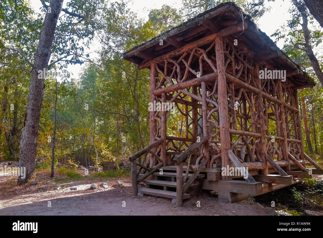 original and creative wooden bridge made with interlaced tree trunks ...