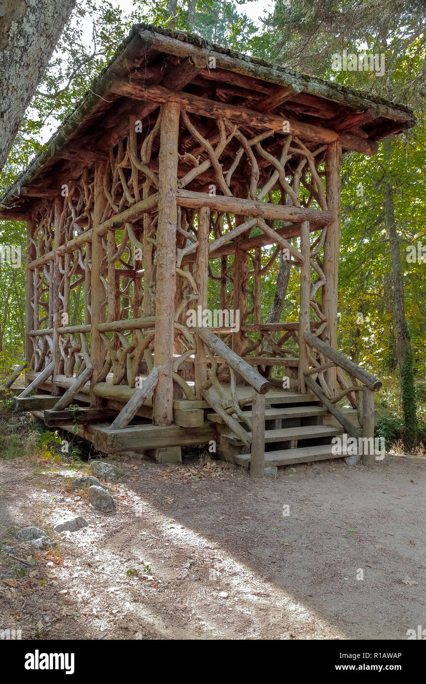 original and creative wooden bridge made with interlaced tree trunks ...