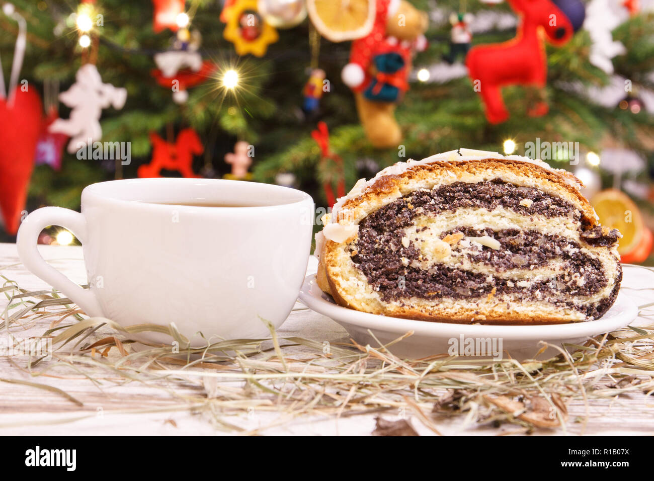 Poppy seeds cake, hot tea or coffee and christmas hay, christmas tree ...