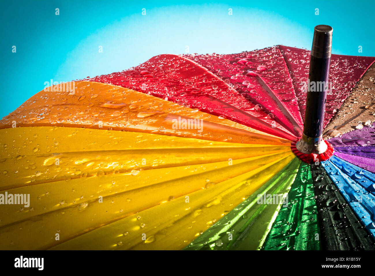 Multi-colored colorful umbrella with all colors of the rainbow with ...