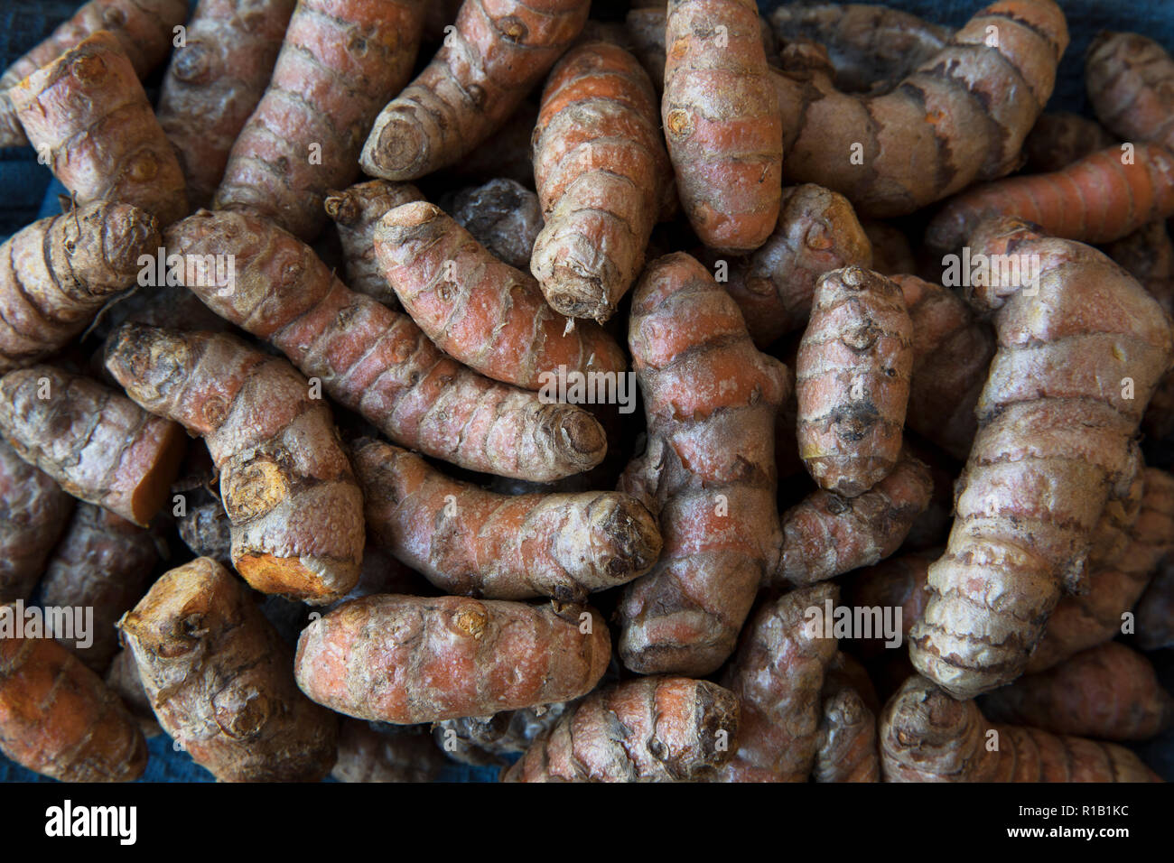 Turmeric root food background Stock Photo - Alamy