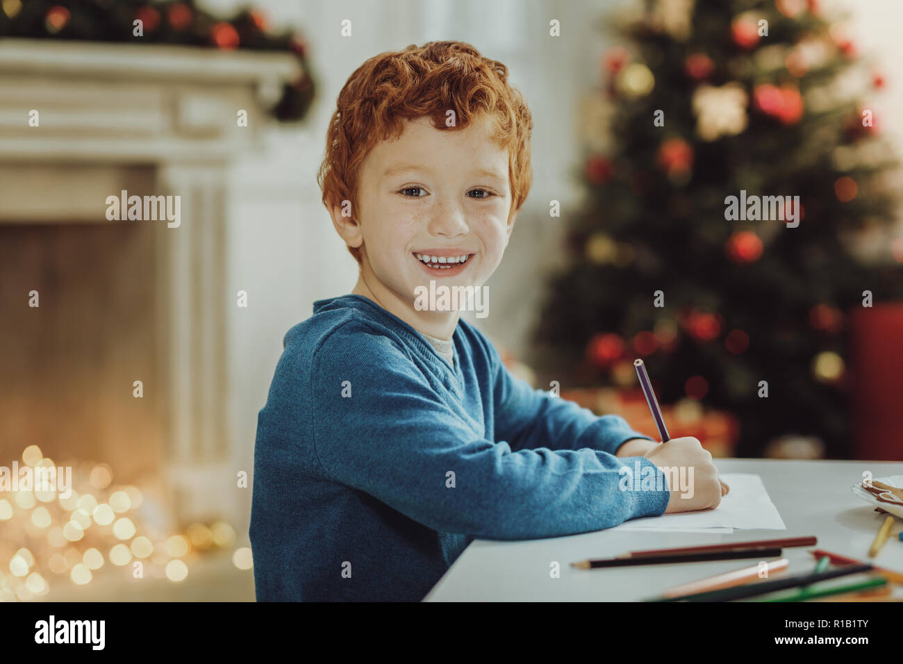 Happy kid drawing funny pictures Stock Photo - Alamy