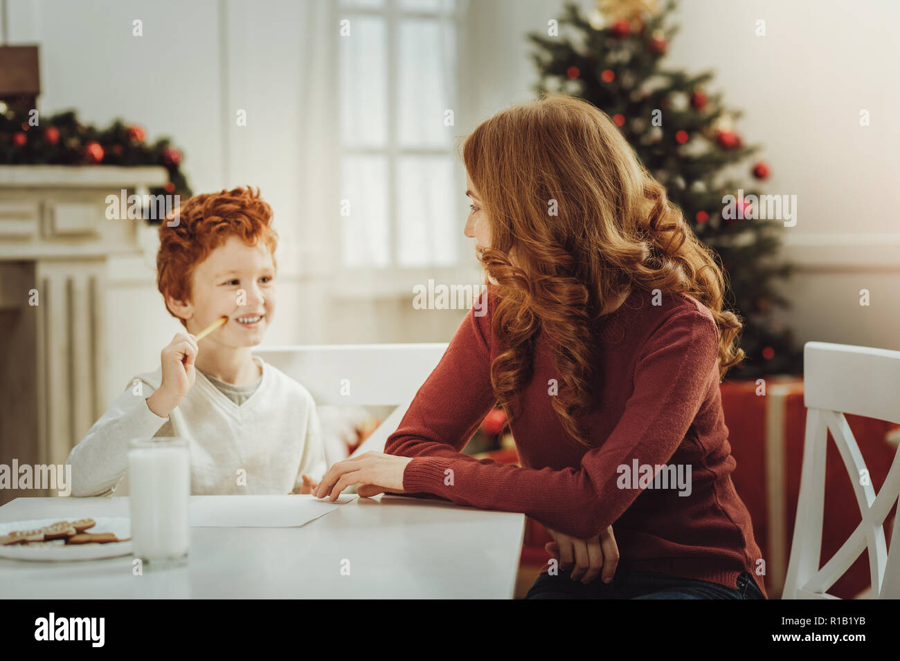 Delighted child looking at his pretty mother Stock Photo - Alamy