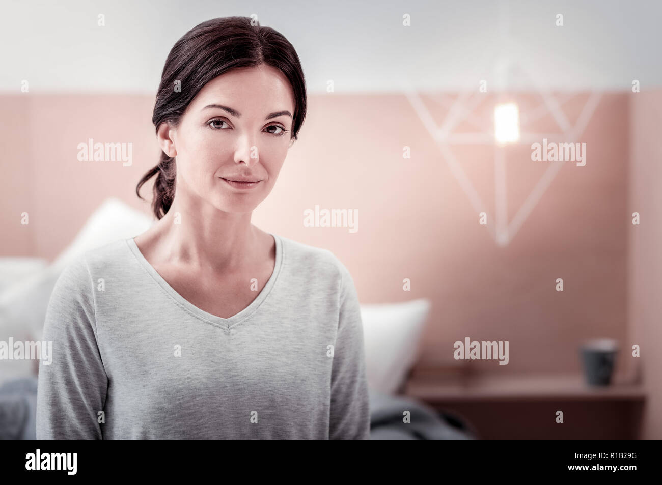 Portrait of young woman expressing calmness Stock Photo - Alamy