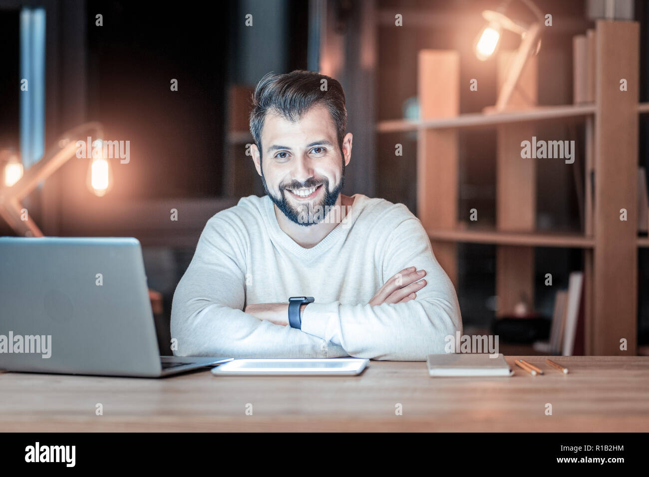 Attractive young man waiting for task Stock Photo - Alamy