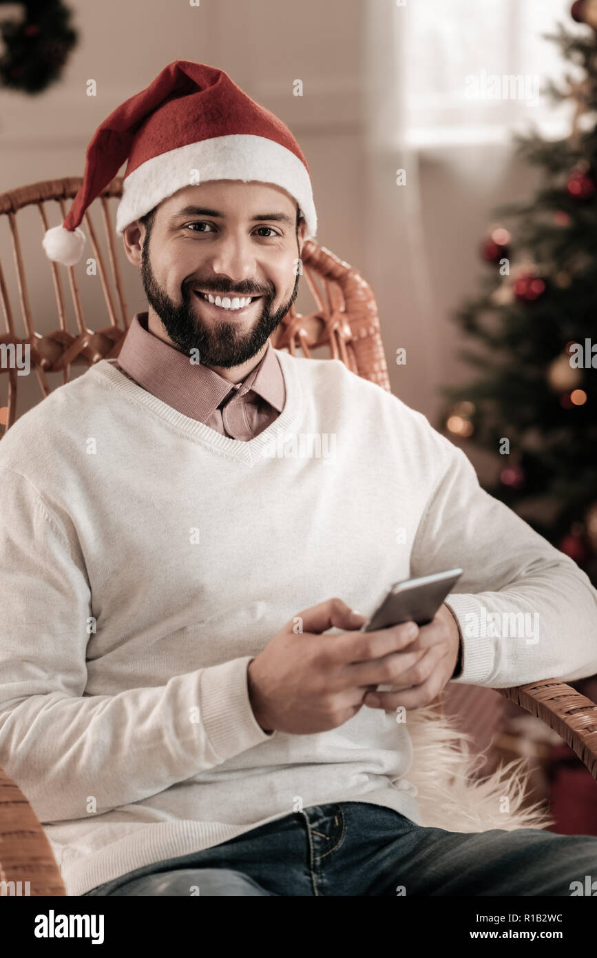 Handsome bearded man keeping smile on his face Stock Photo - Alamy