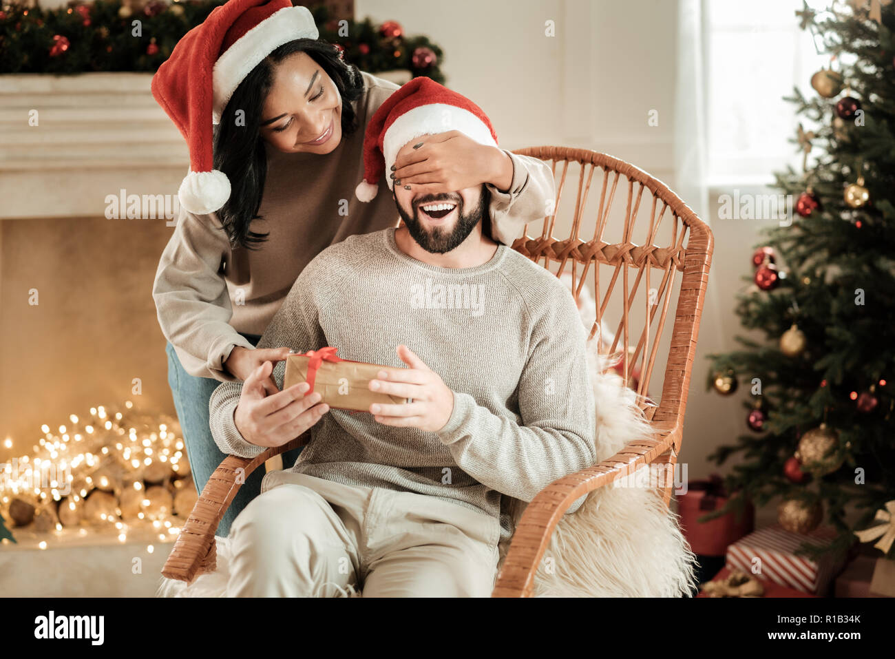 Joyful positive woman preparing a surprise for her Stock Photo - Alamy