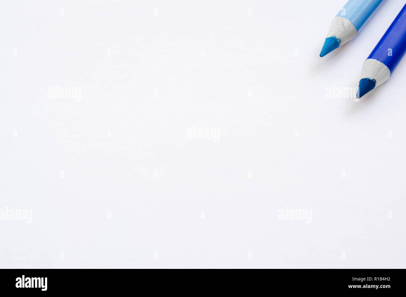 Two blue pencils isolated on white background Stock Photo - Alamy