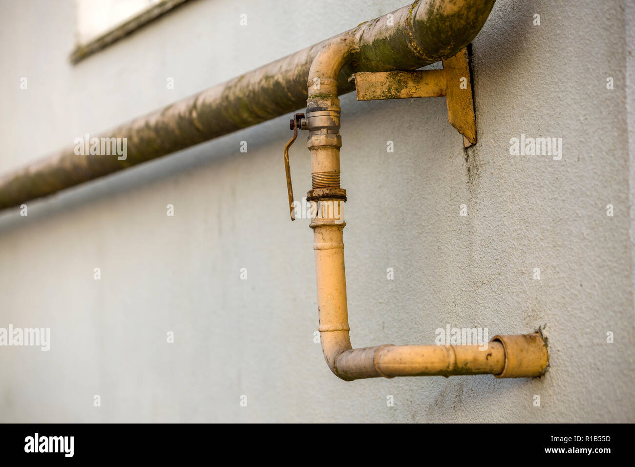 Close-up detail of old dirty painted yellow natural gas pipes with ...