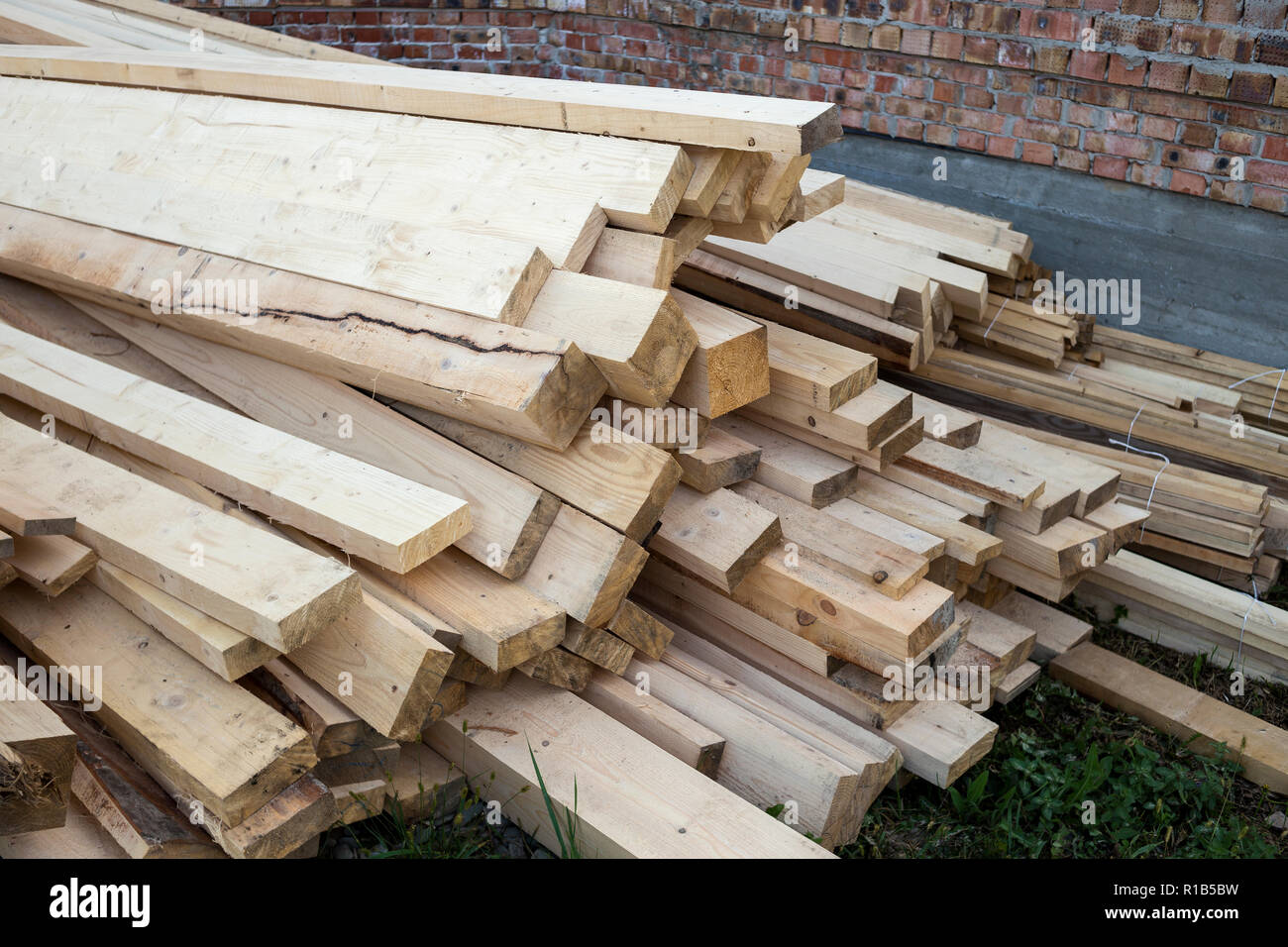 Stack of natural brown uneven rough wooden boards on building site ...