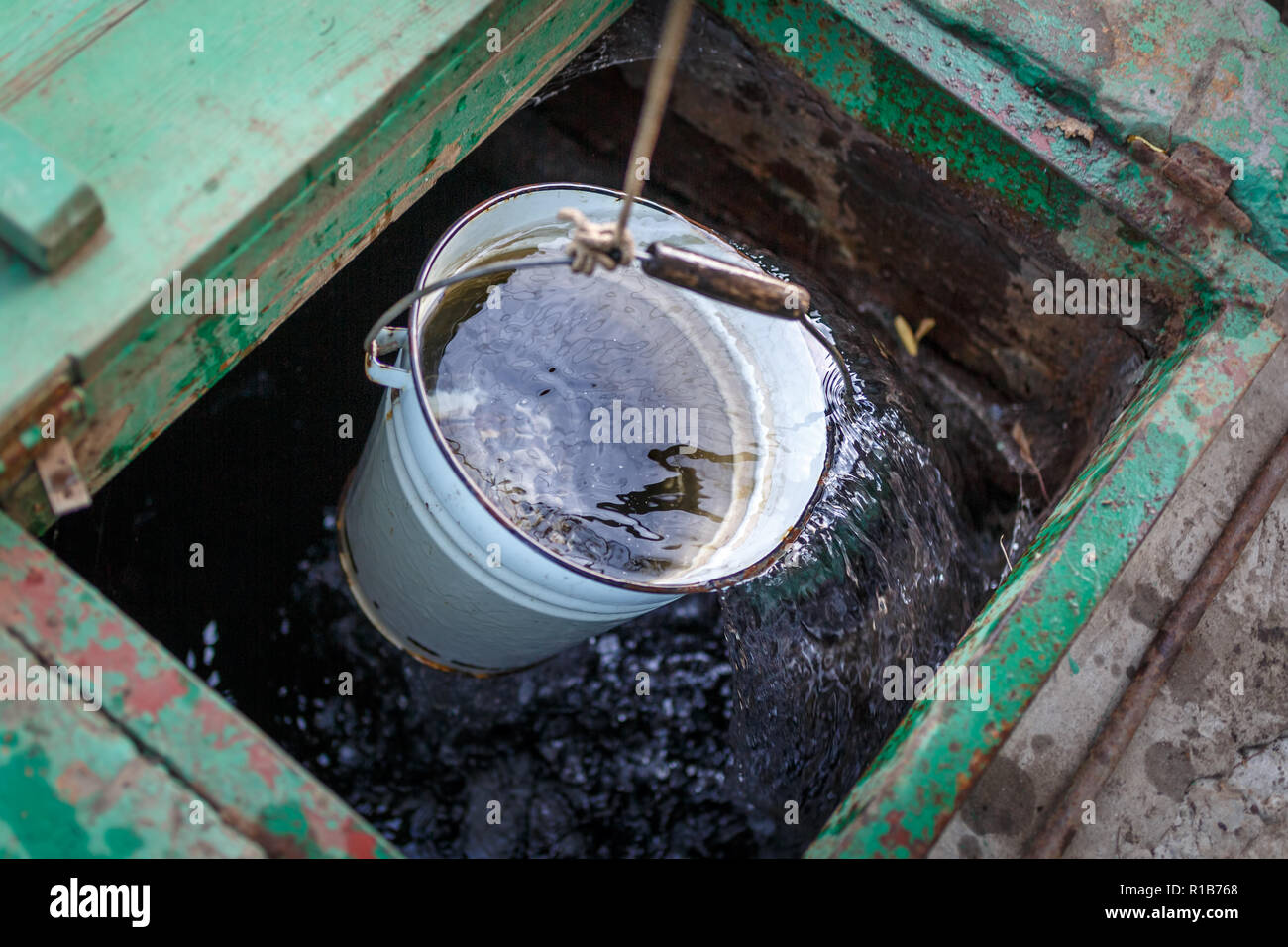Full bucket of clear water got out of a deep well Stock Photo - Alamy