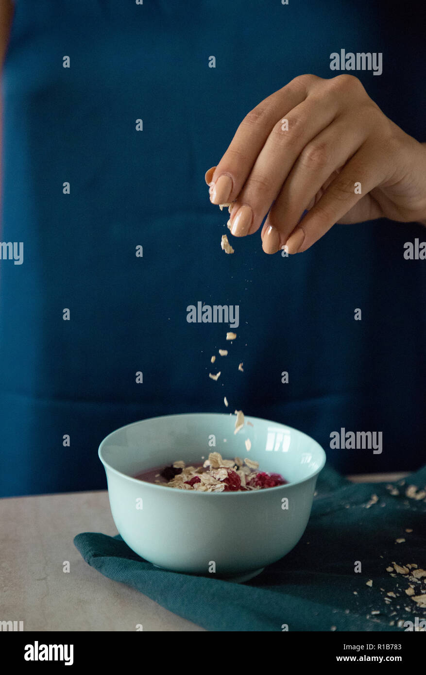 Girl pouring cereal flakes in the breakfast bowl Stock Photo - Alamy