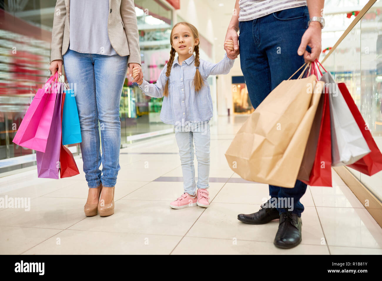 Little Girl Shopping with Parents Stock Photo - Alamy