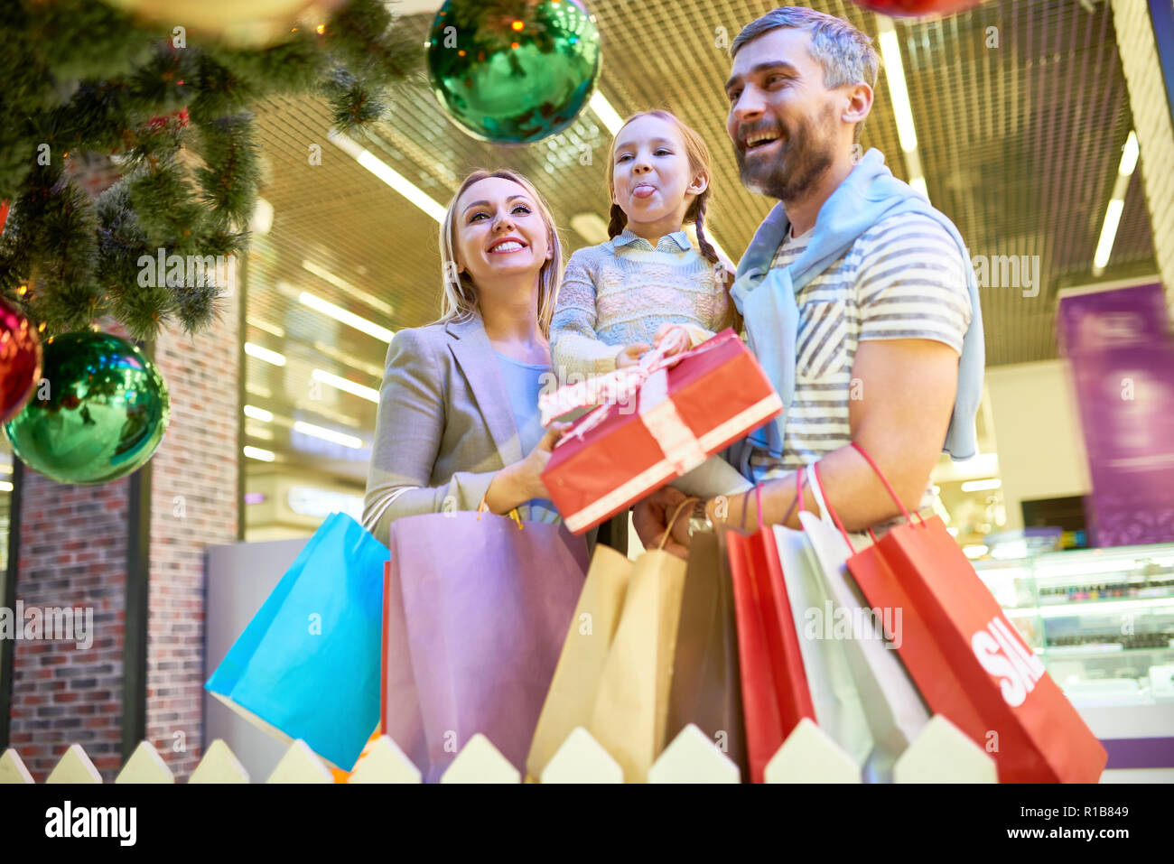 Playful happy family shopping before Christmas Stock Photo - Alamy