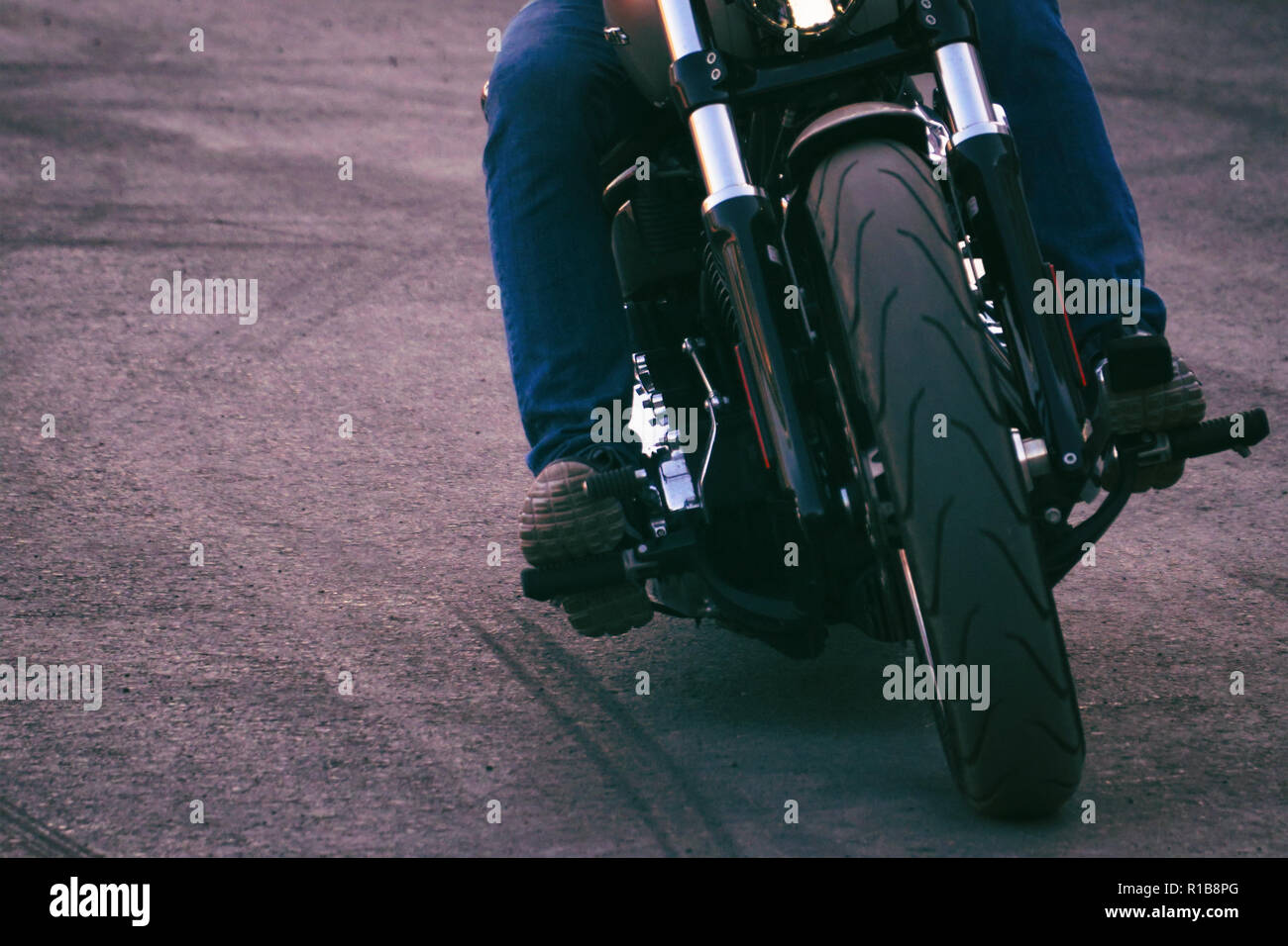 Biker iriding a motorcycle. Front view Stock Photo - Alamy