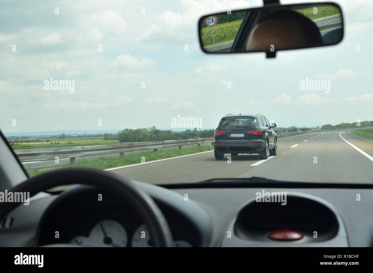 Driving on a highway with another vehicle in front of Stock Photo - Alamy
