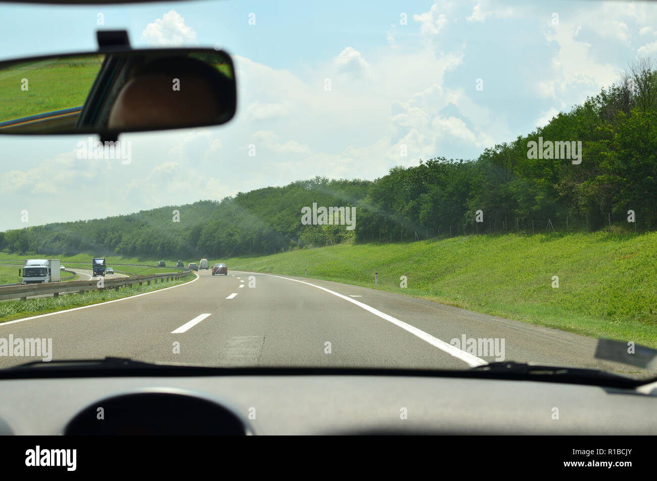 Driving on a highway that goes through beautiful countryside in ...