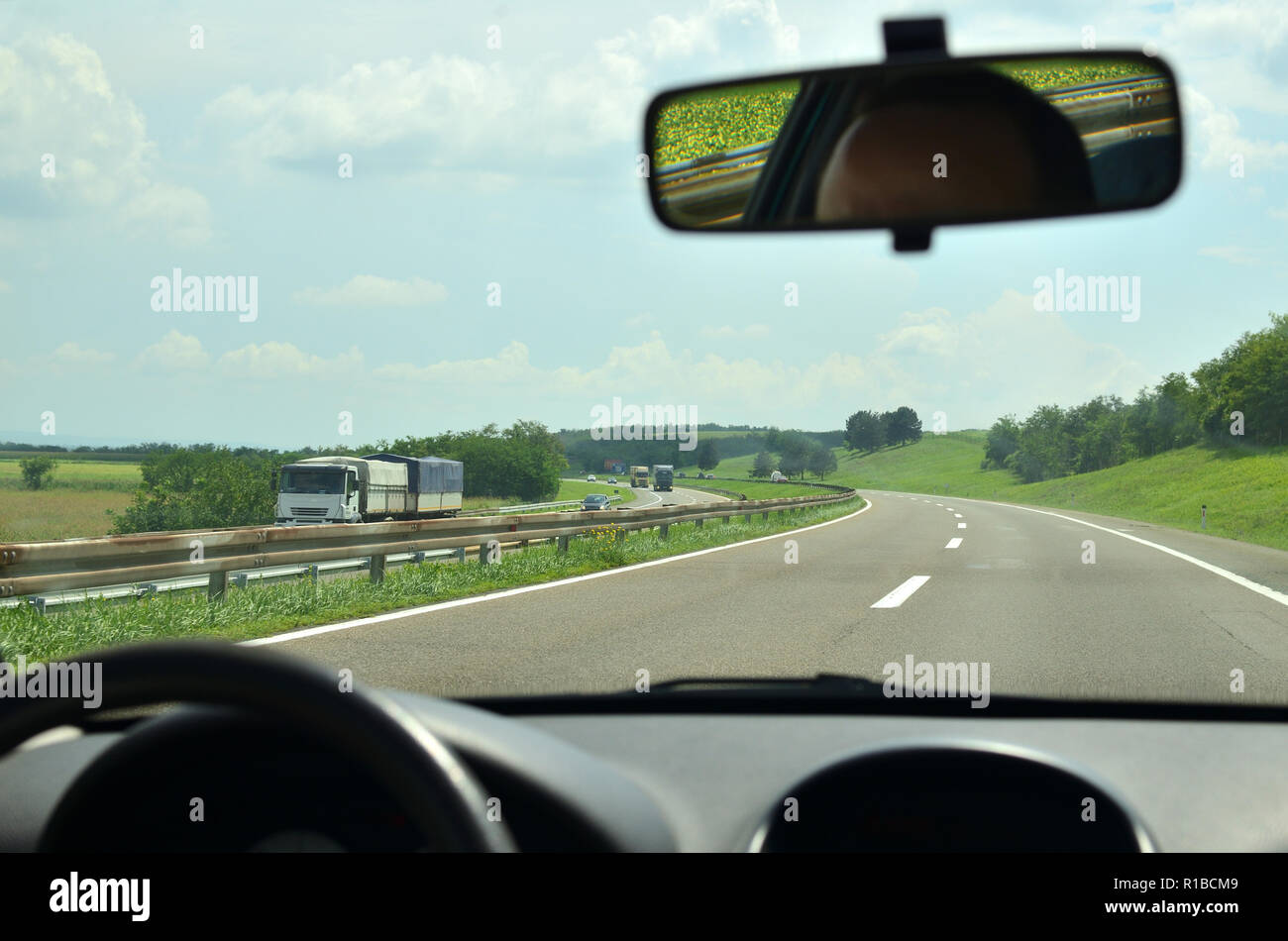 Driving on a highway that goes through a beautiful countryside in ...