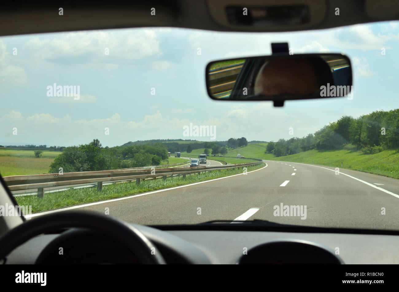 Driving on a highway that goes through beautiful countryside in ...