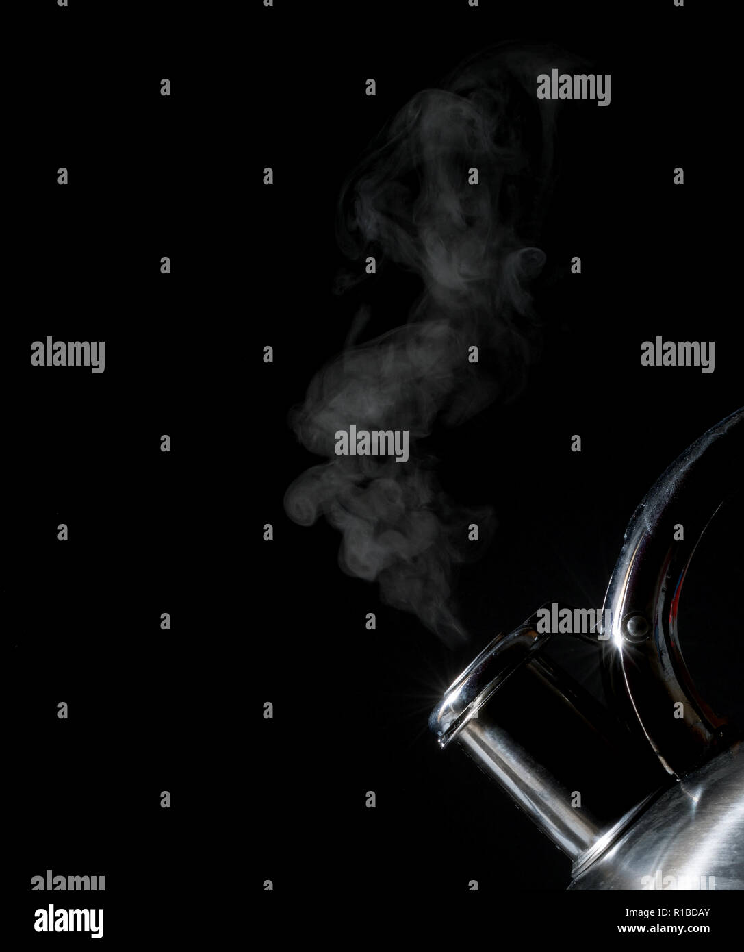 Kettle whistling, boiling kettle, steam, isolated on a black background ...