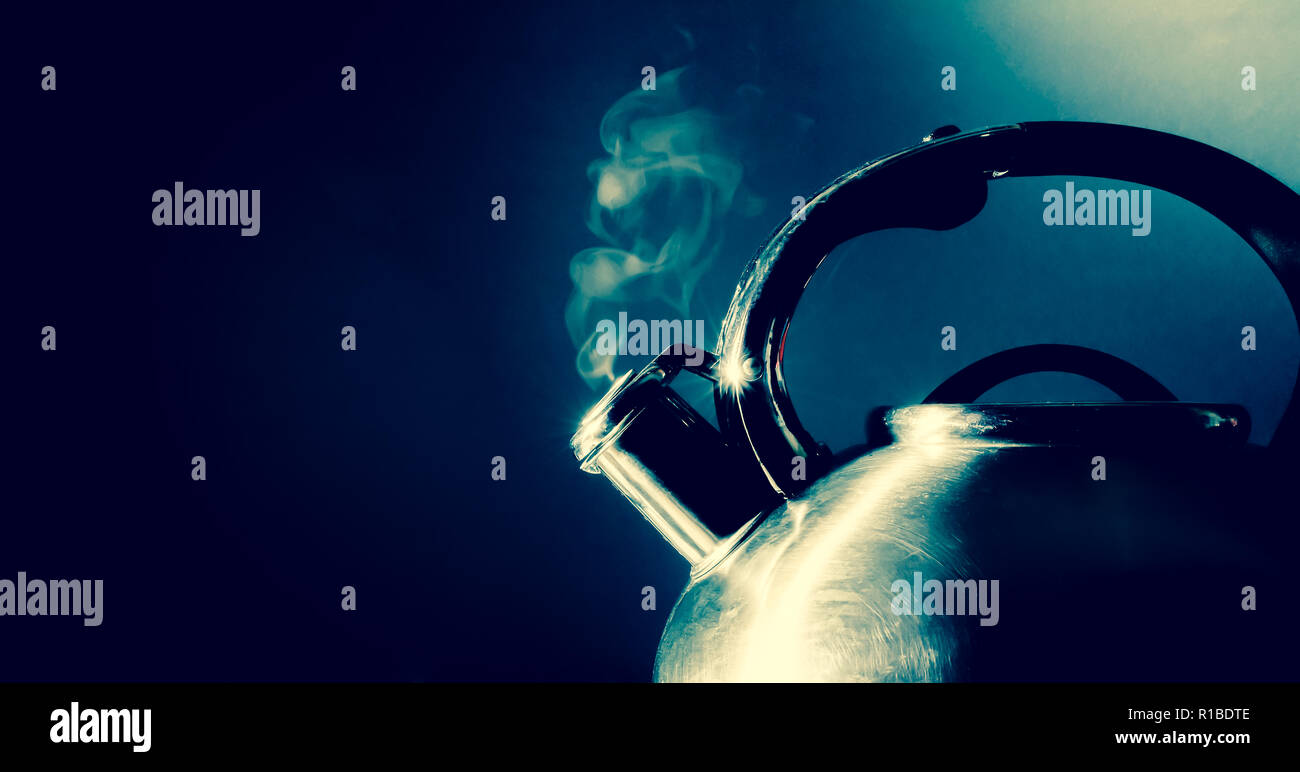 Kettle whistling, boiling kettle, steam, isolated on a black background ...