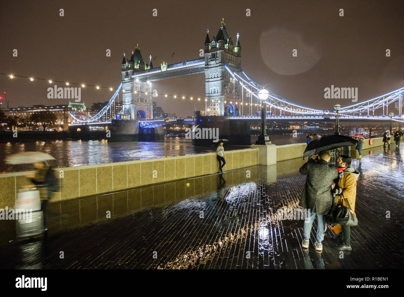 London, UK. 10th Nov, 2018. A man poses for a photograph on a wet ...