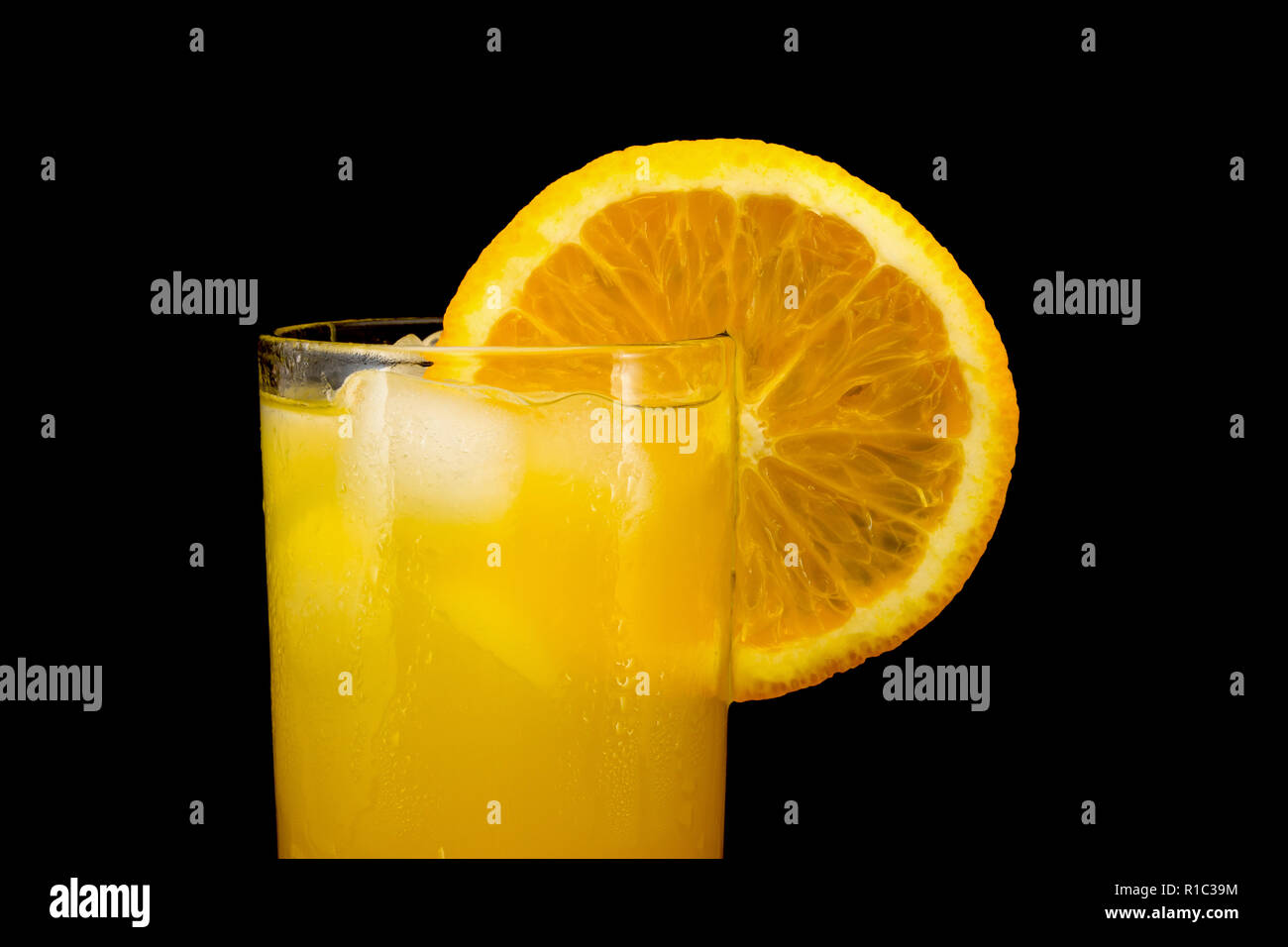 Glass of fresh orange juice with ice and a slice of orange isolated on ...