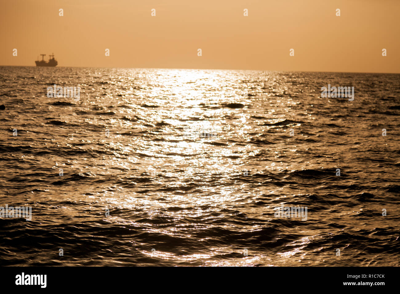 landscape sea with waves and sunset sky with a ship Stock Photo - Alamy