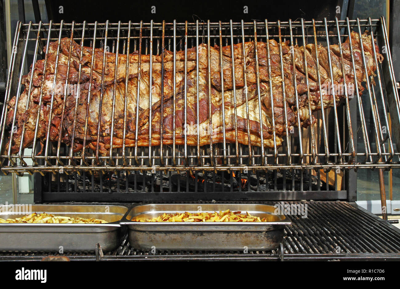 Whole pig roasted on a big grill. Kind of Cheverme, whole animal ...