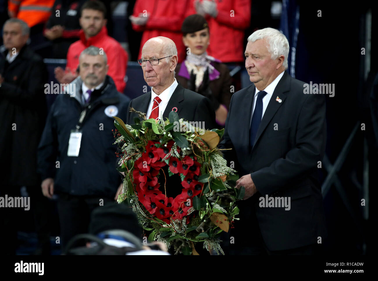 Sir Bobby Charlton (left) and Mike Summerbee carry out a wreath before ...