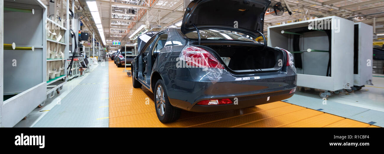 Car without doors on production line. Long format. Wide angle view of ...