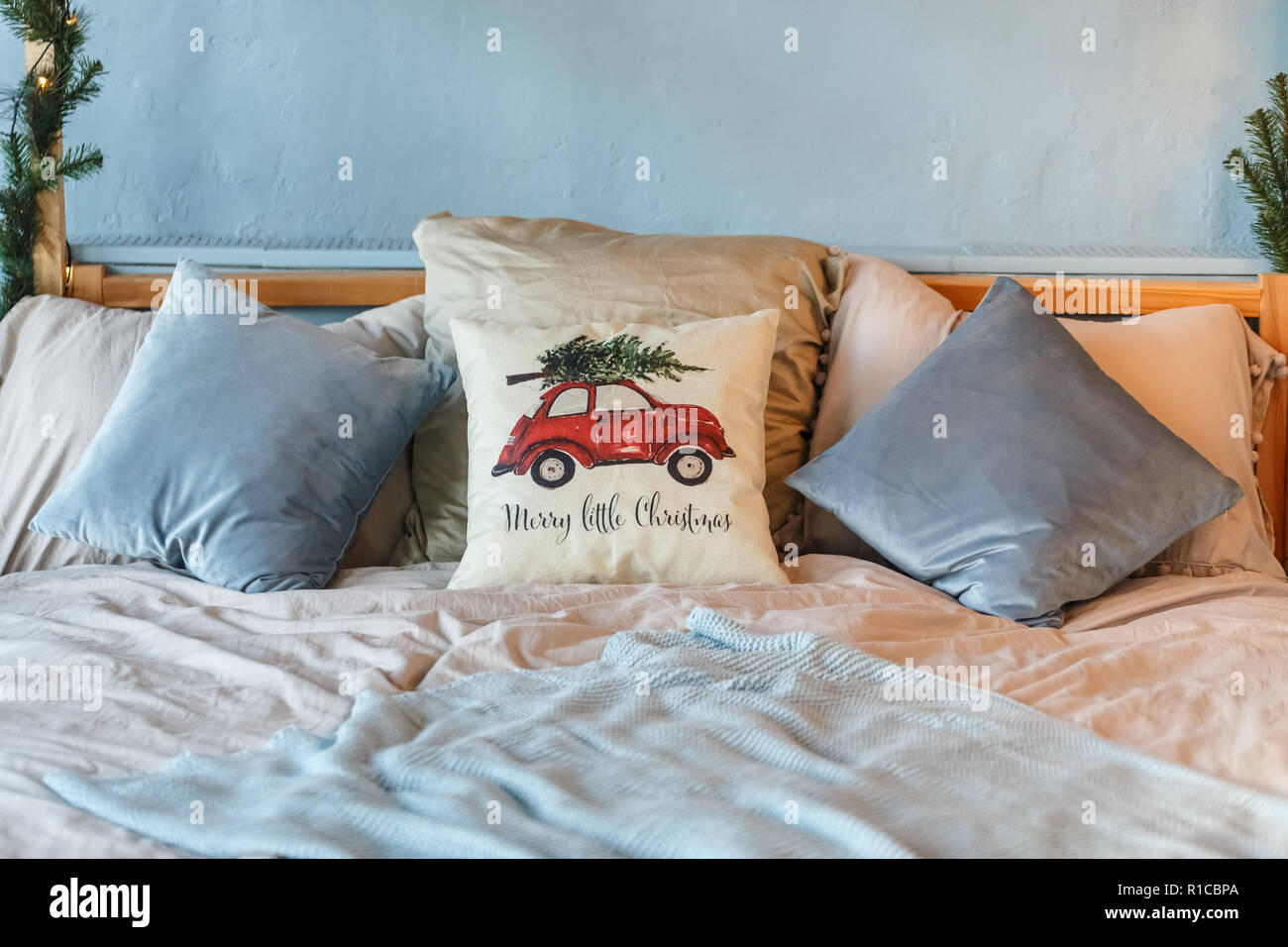 Bed decorated for Christmas with pillows and lights Stock Photo - Alamy