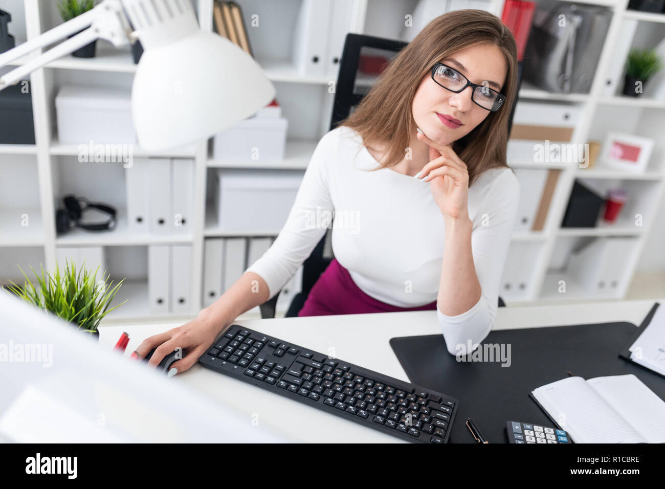 Portrait of a young girl at a computer Desk in the office Stock Photo ...