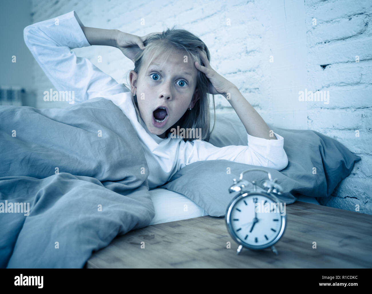 Sweet sleepless little girl stressed sad and angry in bed looking at ...